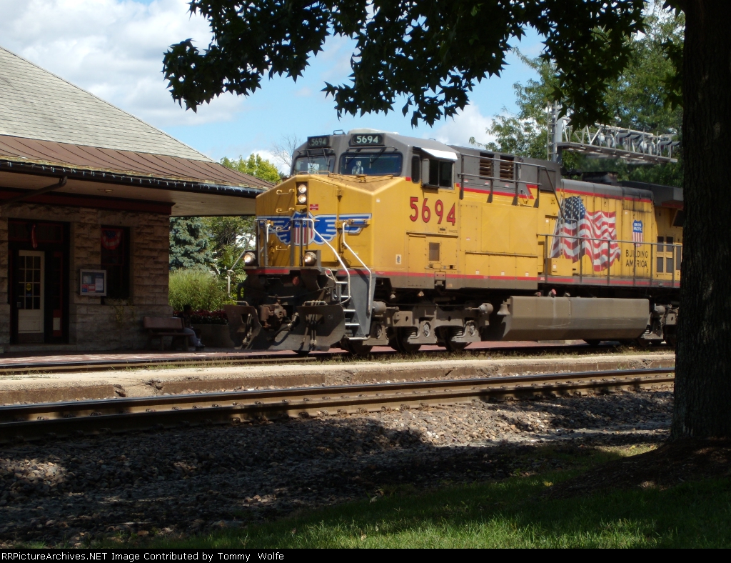 UP 5694 leads empty coal west past the Kirkwood Amtrak Station